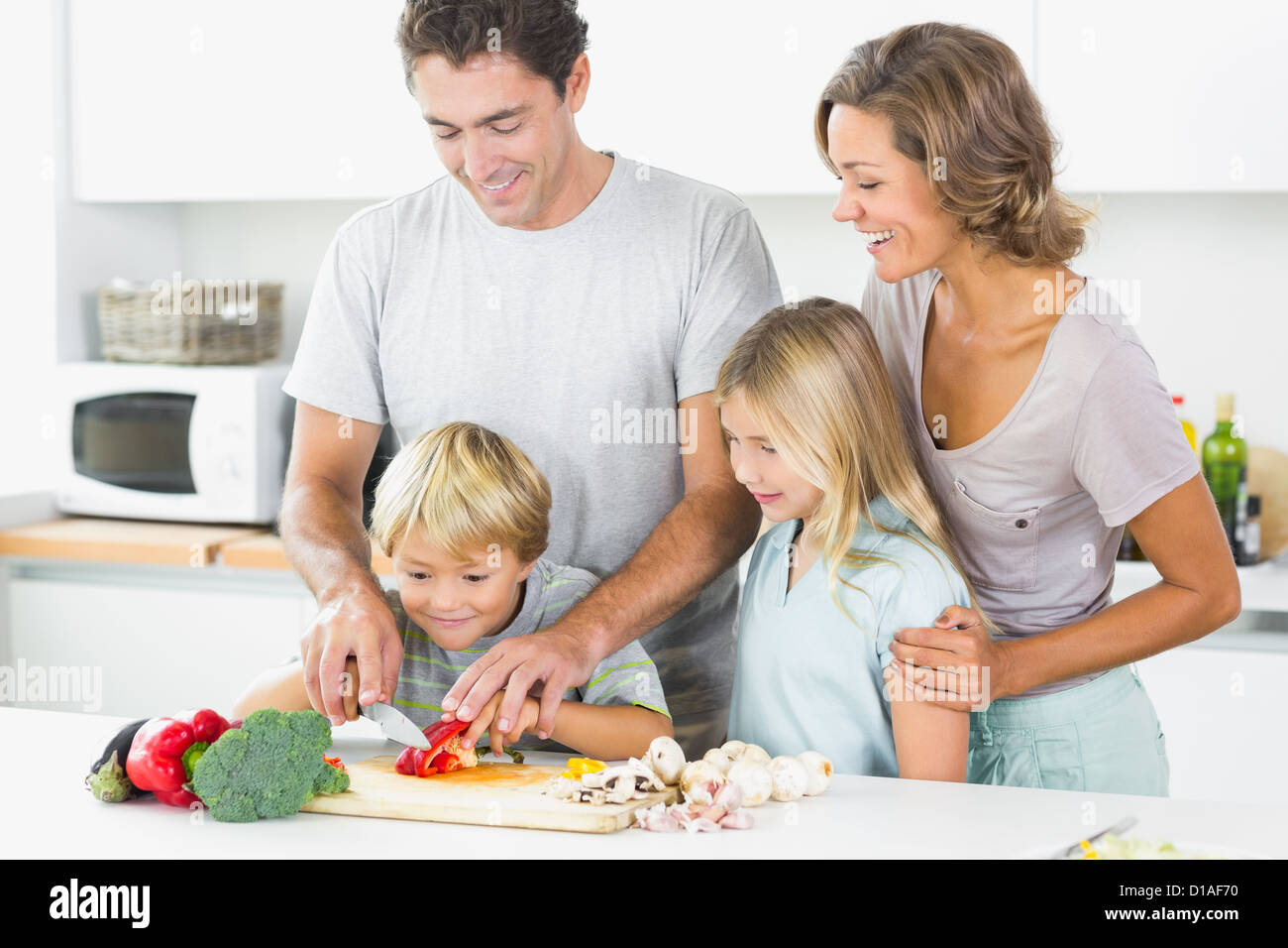 Family preparing vegetables together Stock Photo - Alamy
