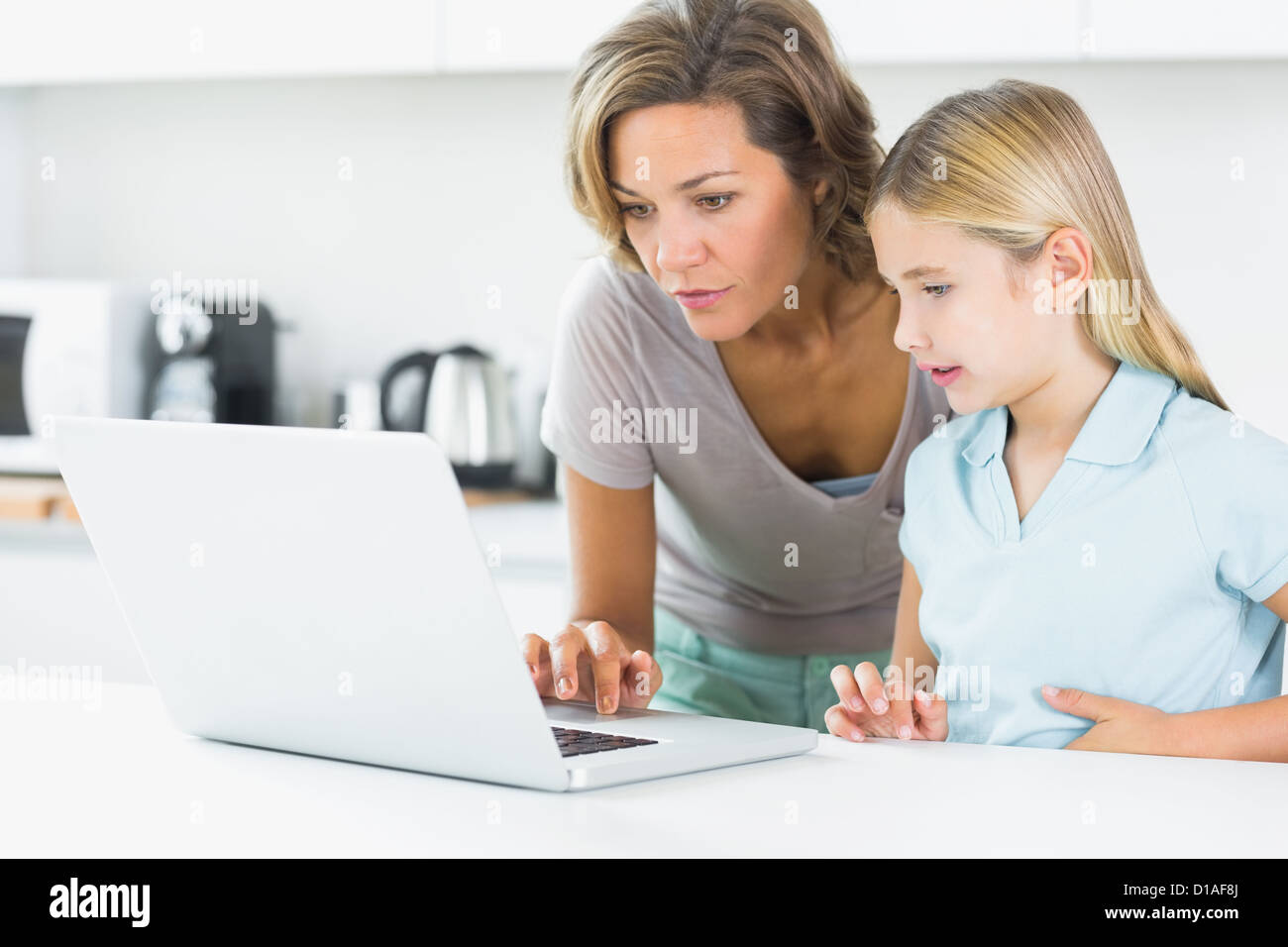 Mother and daughter using laptop Stock Photo - Alamy