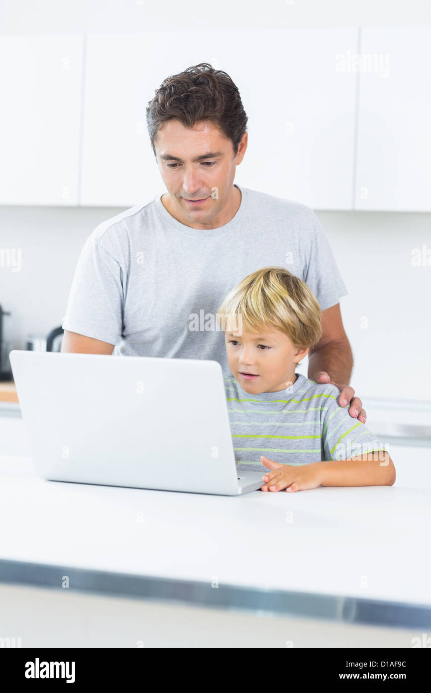 Father and son using laptop Stock Photo - Alamy