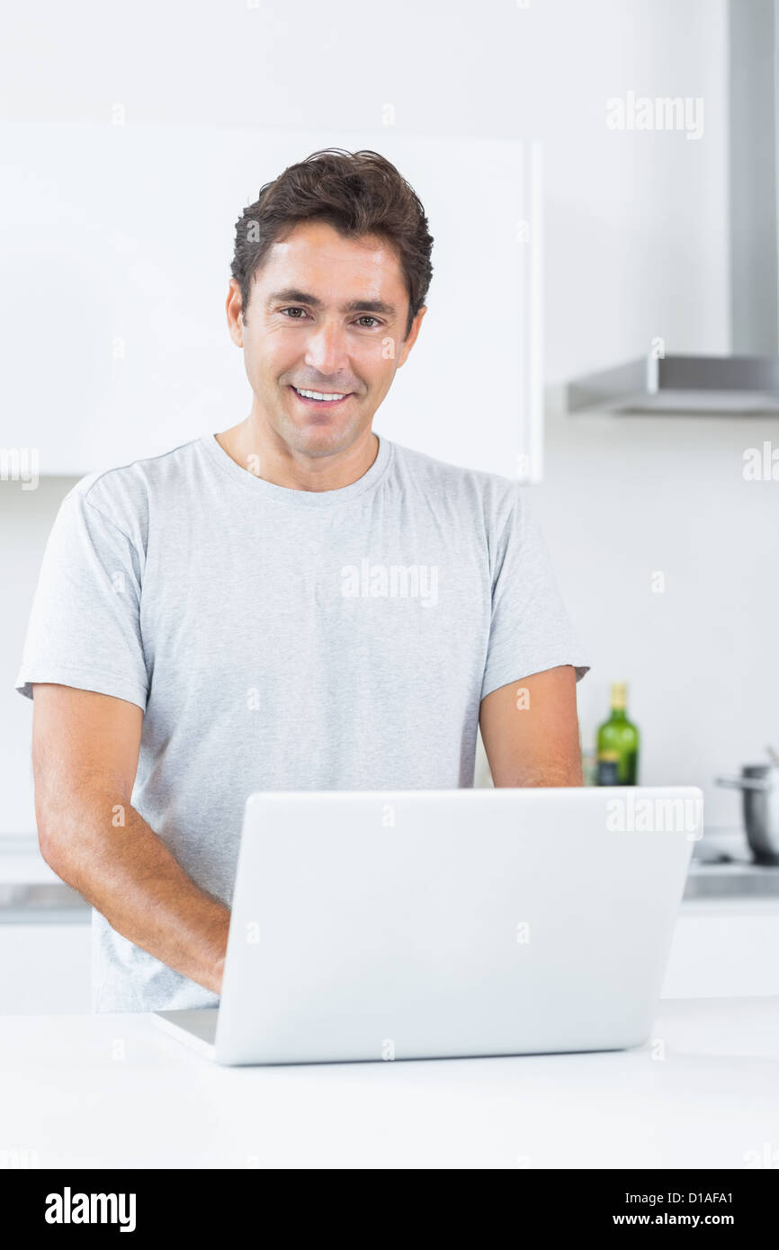Smiling man with laptop Stock Photo - Alamy