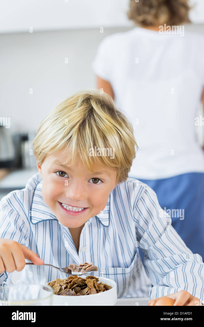 Smiling boy having breakfast Stock Photo - Alamy