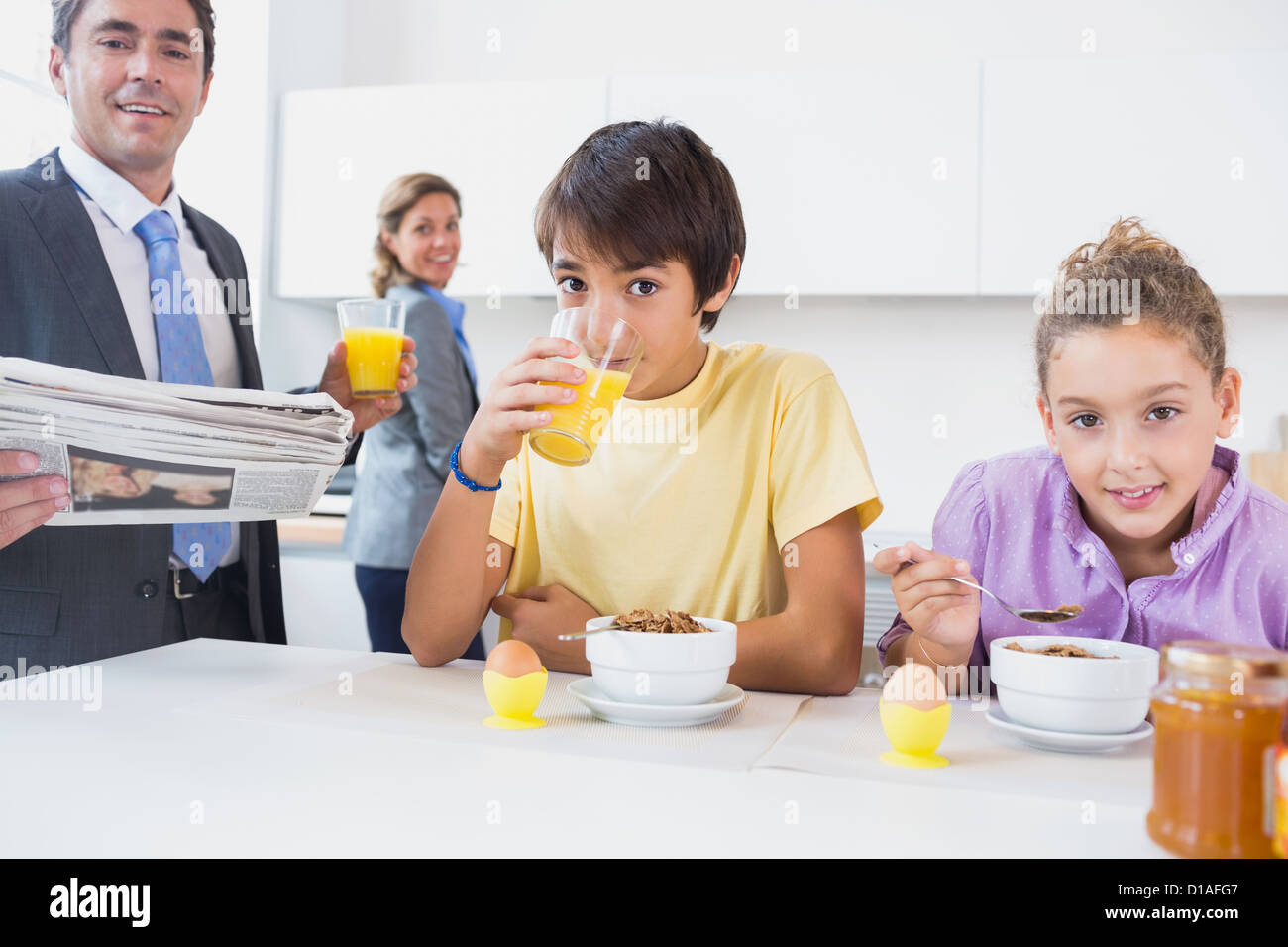 Smiling family at breakfast time Stock Photo - Alamy