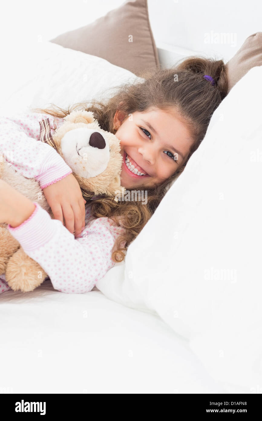 Little girl cuddling teddy bear Stock Photo - Alamy