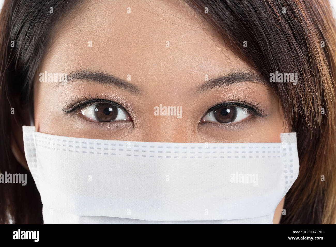 Close-up portrait of Chinese woman wearing a surgical mask Stock Photo ...
