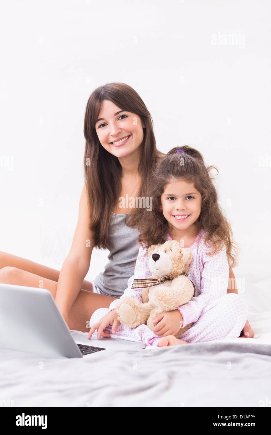 Happy mother and daughter with laptop Stock Photo - Alamy
