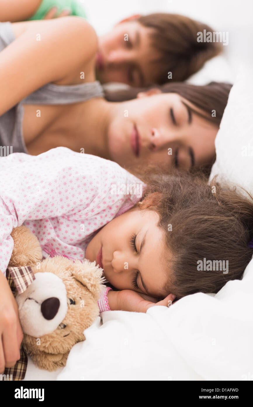 Mother and children cuddled up in bed Stock Photo - Alamy