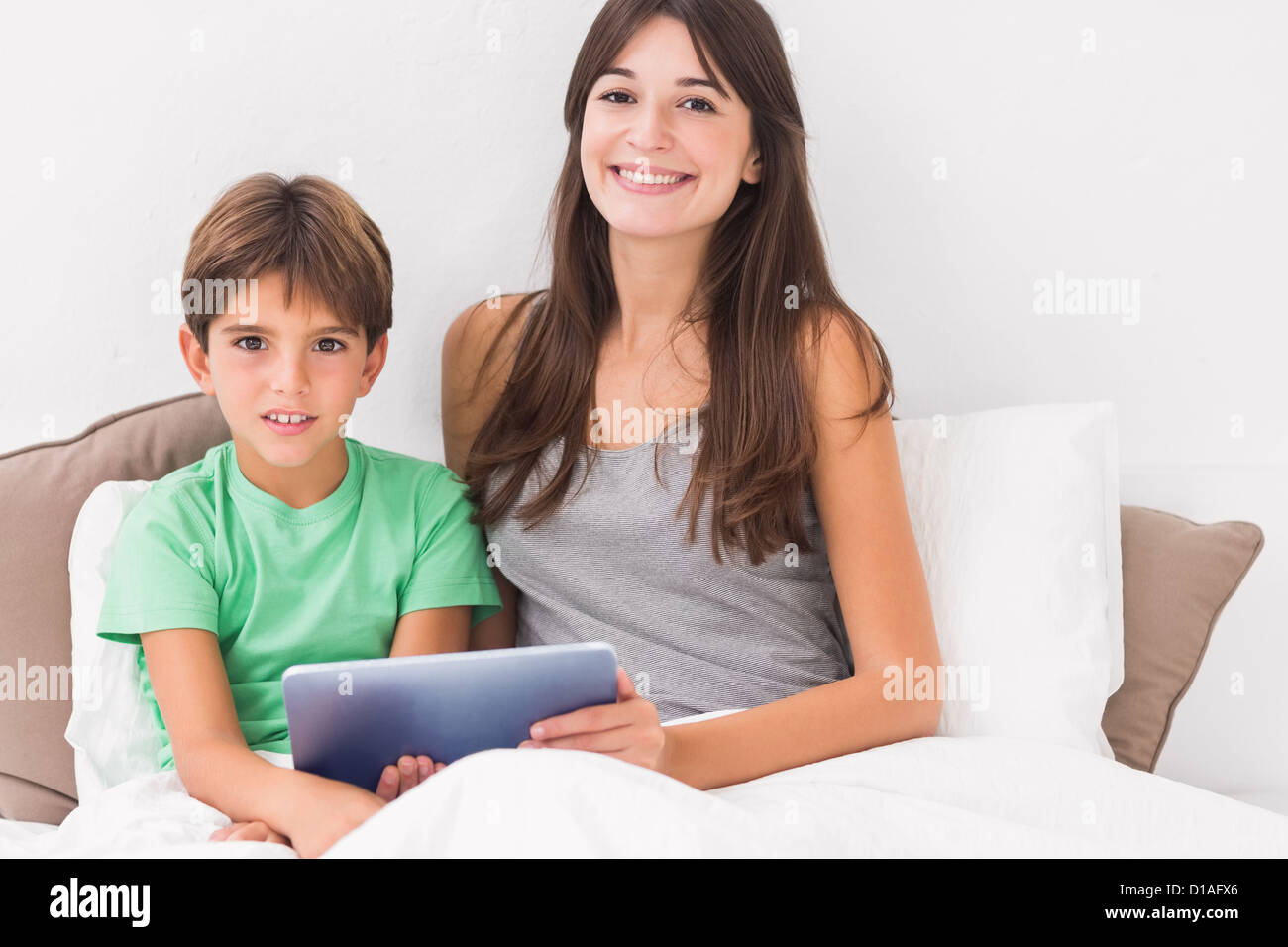 Happy mother and son using digital tablet Stock Photo - Alamy