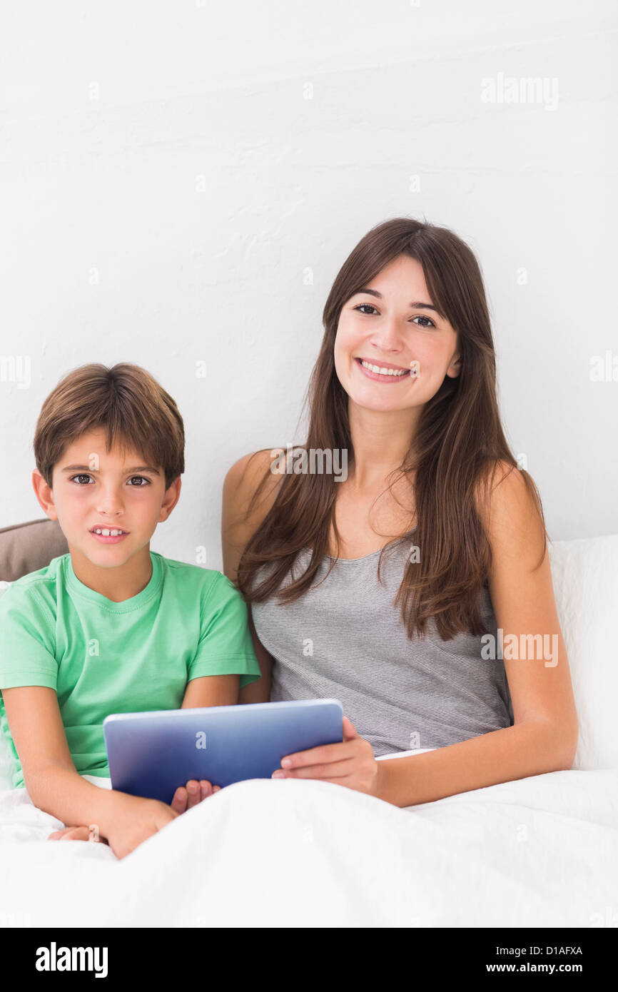 Smiling son and mother using tablet Stock Photo - Alamy