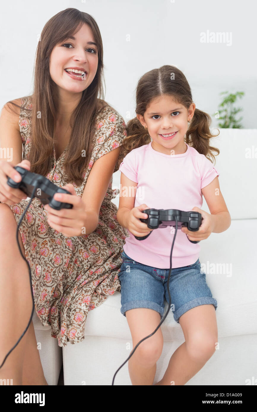Mother and daughter playing video games Stock Photo - Alamy