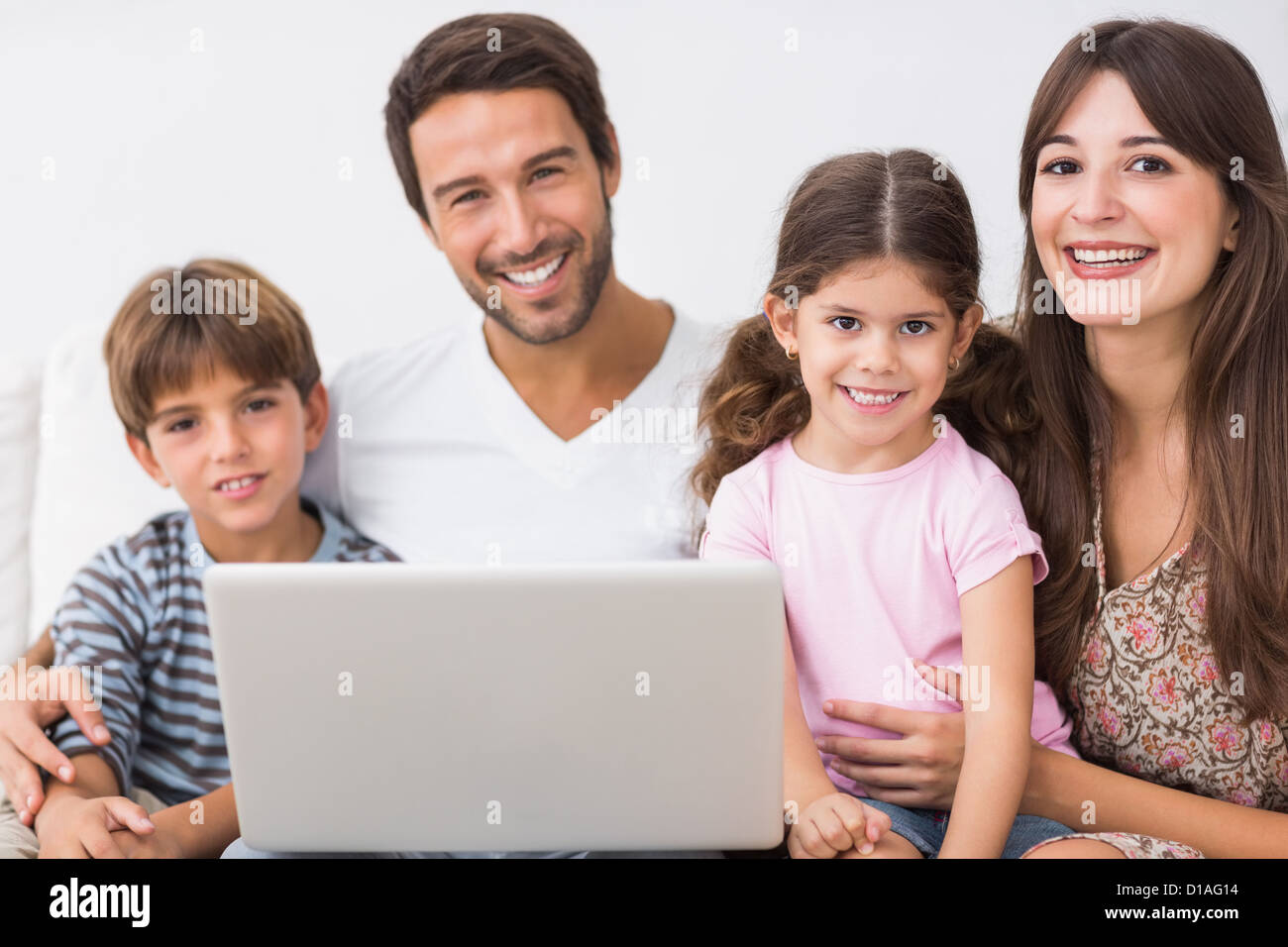 Happy family with laptop Stock Photo - Alamy