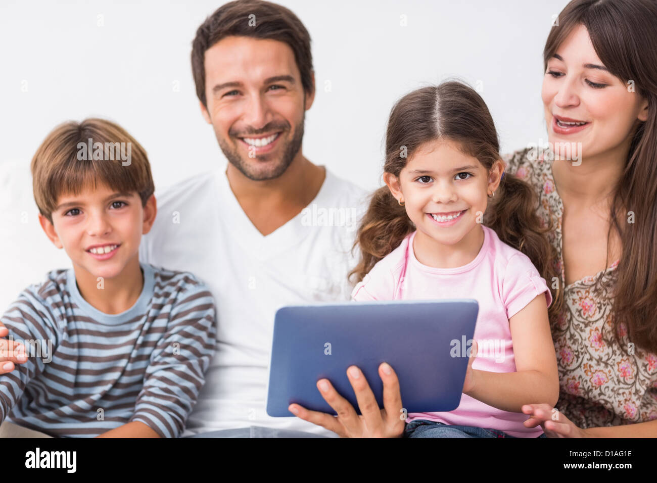 Happy family with tablet pc Stock Photo - Alamy