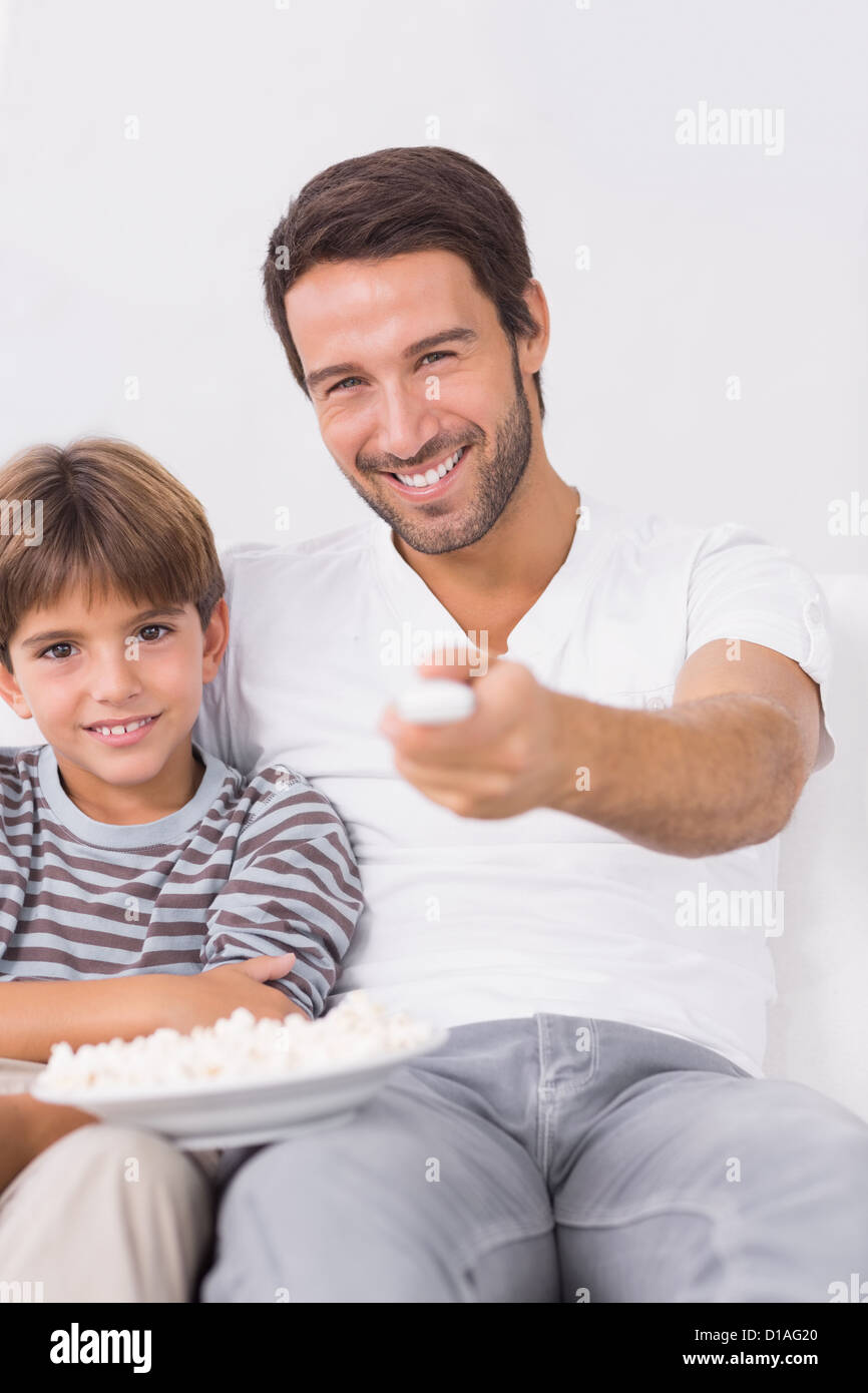 Smiling father and son watching tv Stock Photo - Alamy