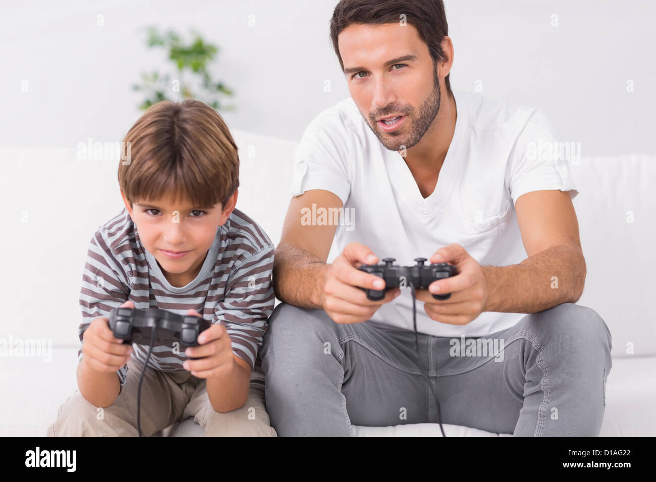 Father and son playing video games Stock Photo - Alamy