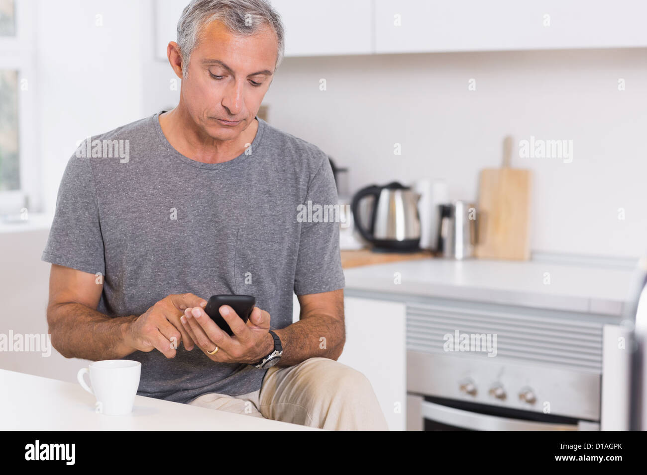 Focused man touching his smartphone Stock Photo - Alamy