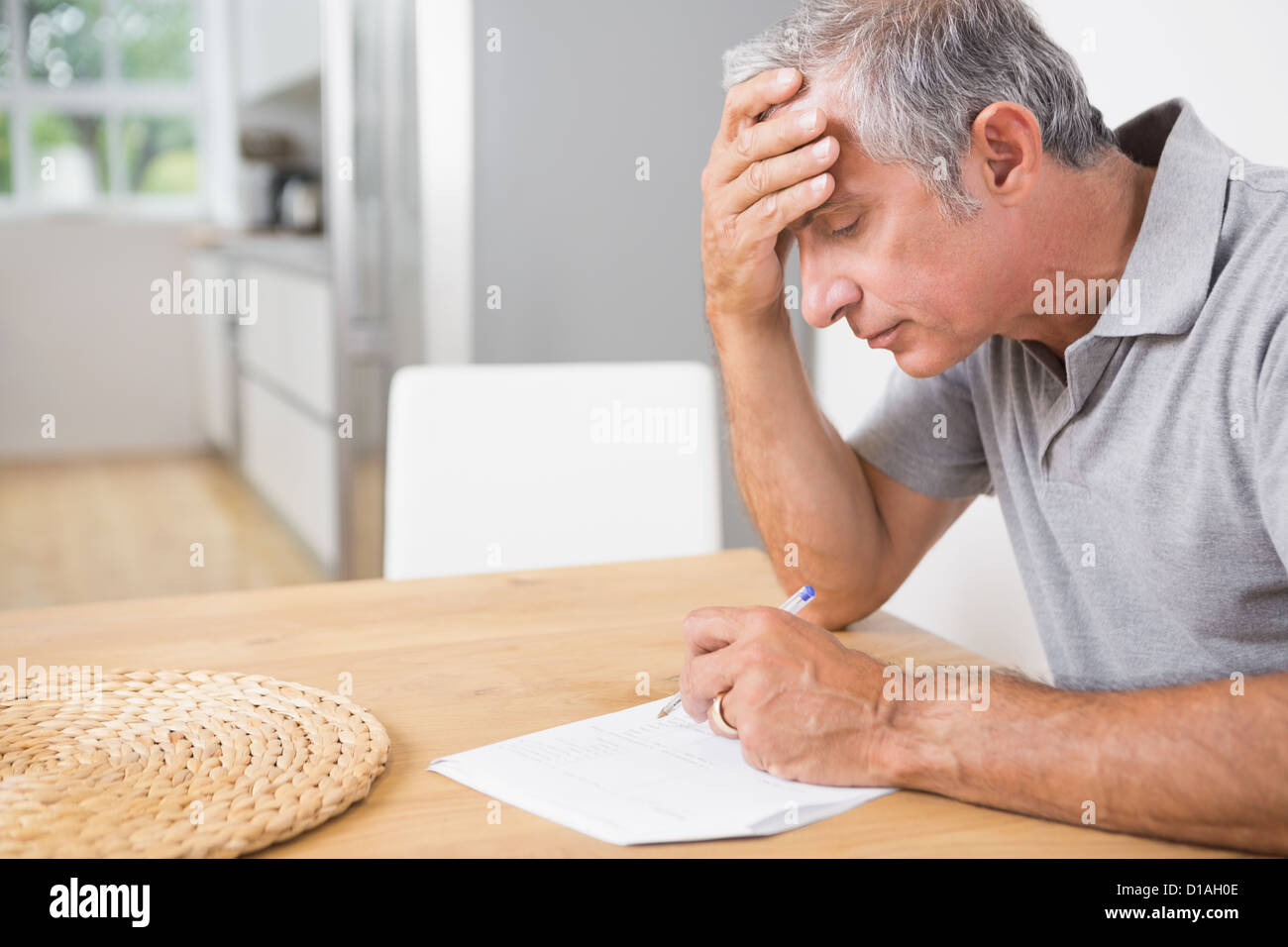 Focused man reading documents Stock Photo - Alamy