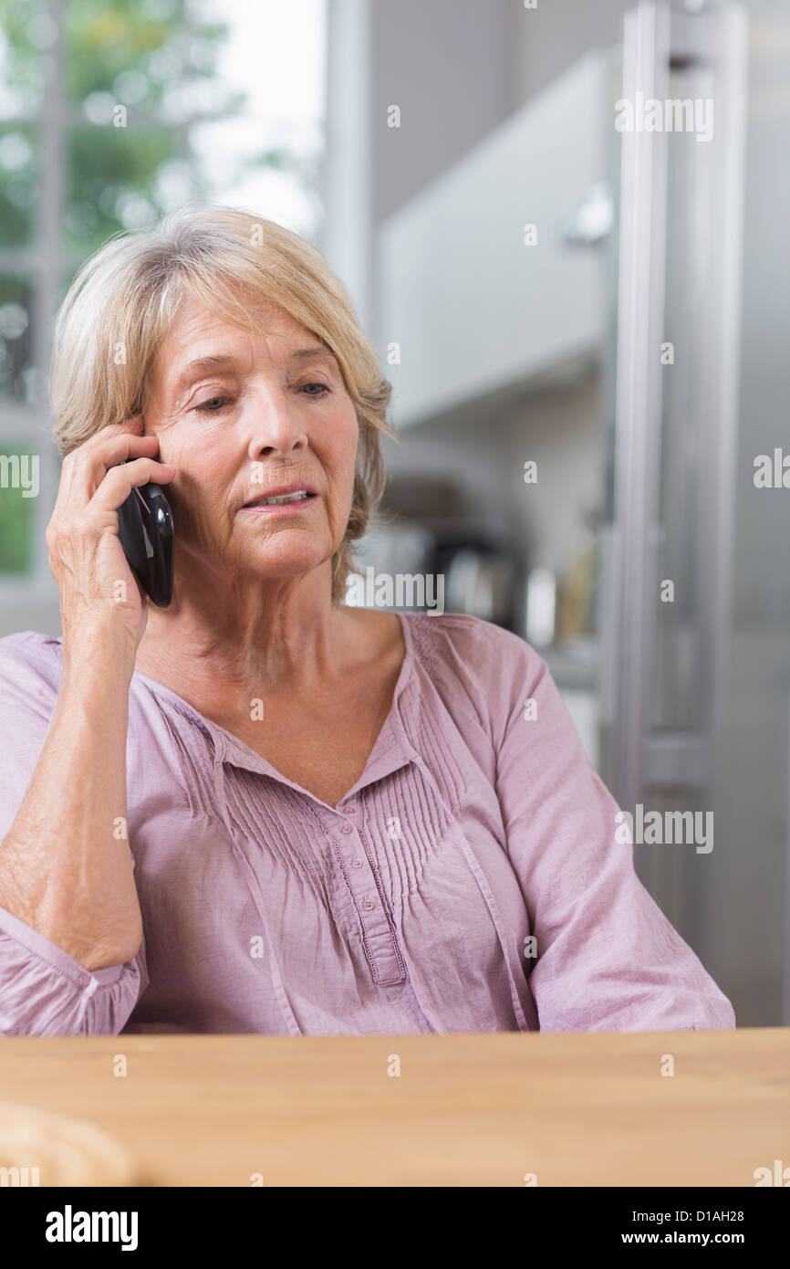 Serious mature woman calling Stock Photo - Alamy