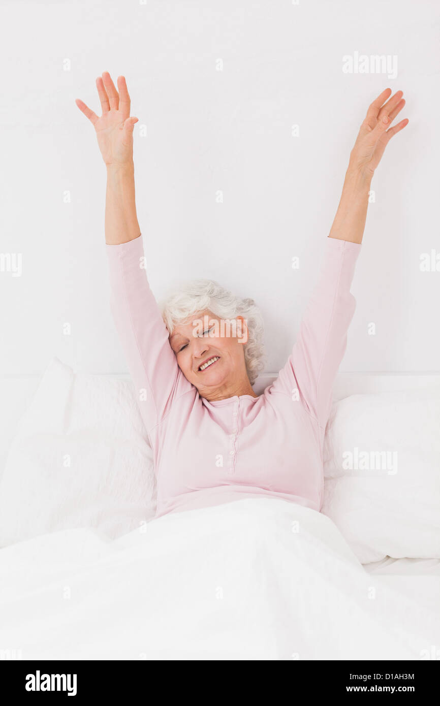 Woman yawning and stretching Stock Photo - Alamy