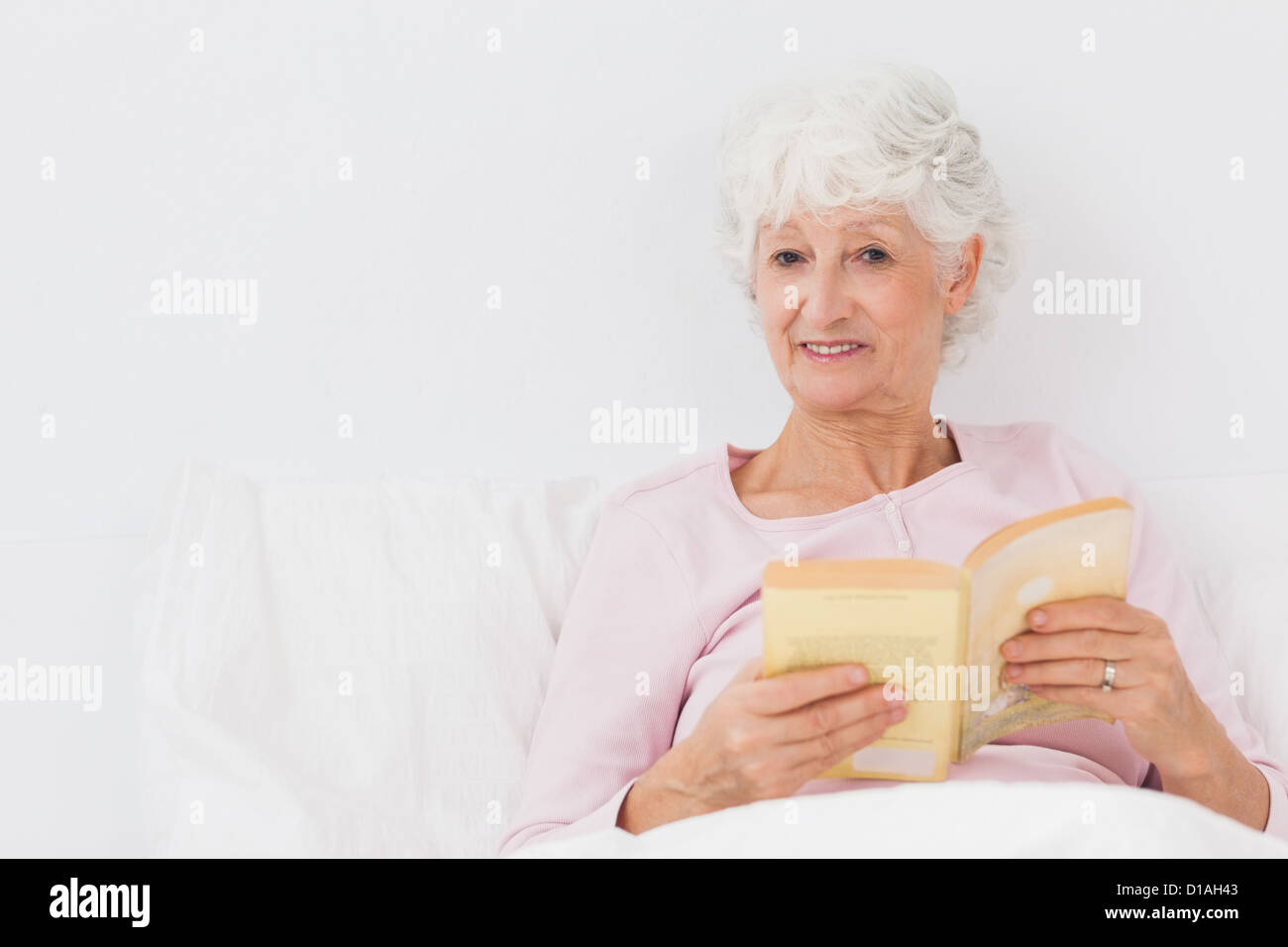 Happy woman with book Stock Photo - Alamy