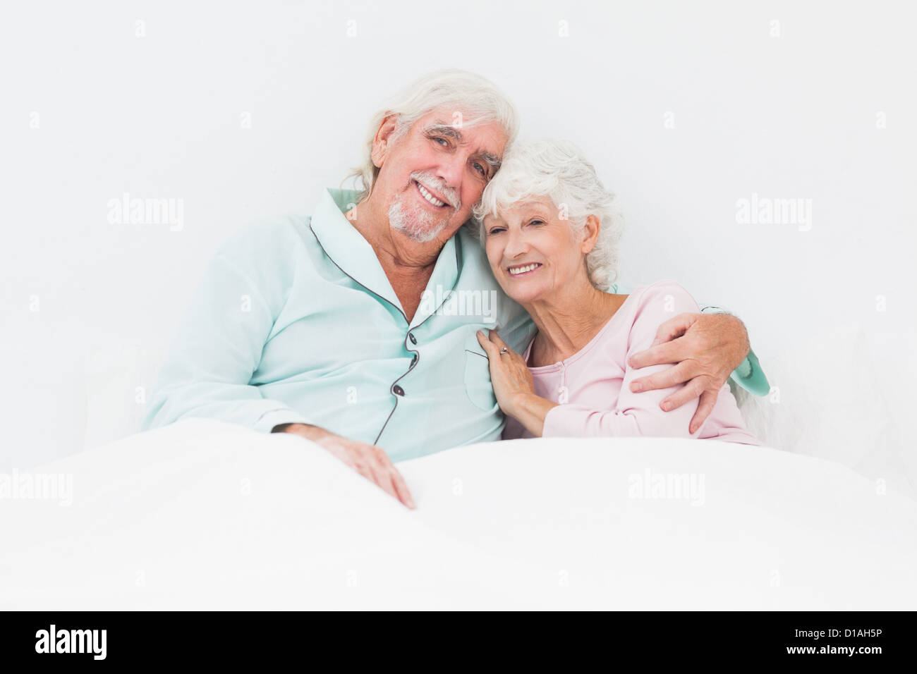 Smiling couple in bed Stock Photo - Alamy