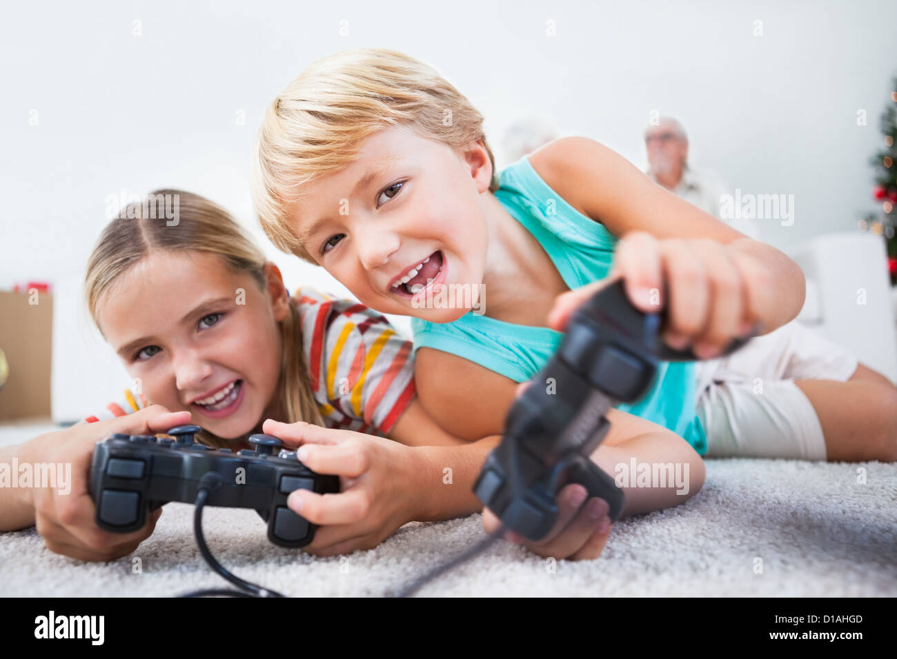 Siblings having fun playing video games Stock Photo - Alamy