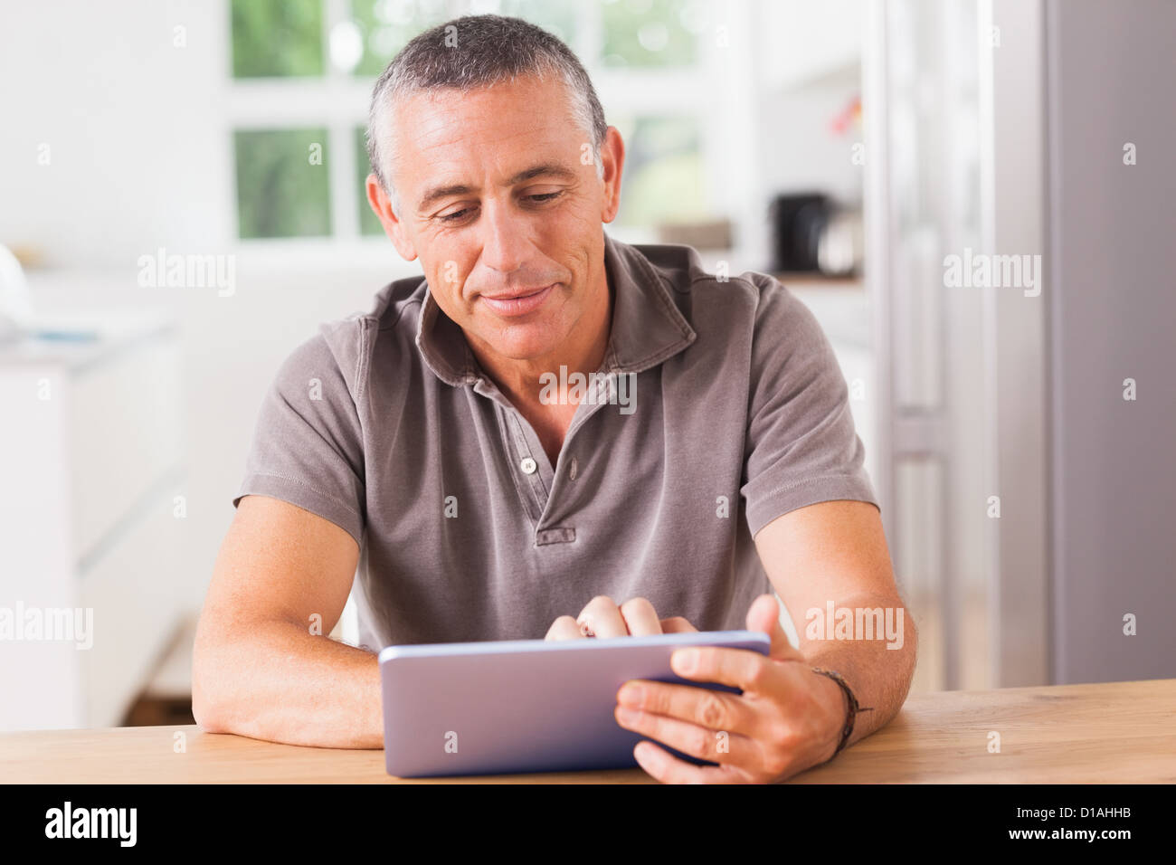 Happy man using tablet Stock Photo - Alamy