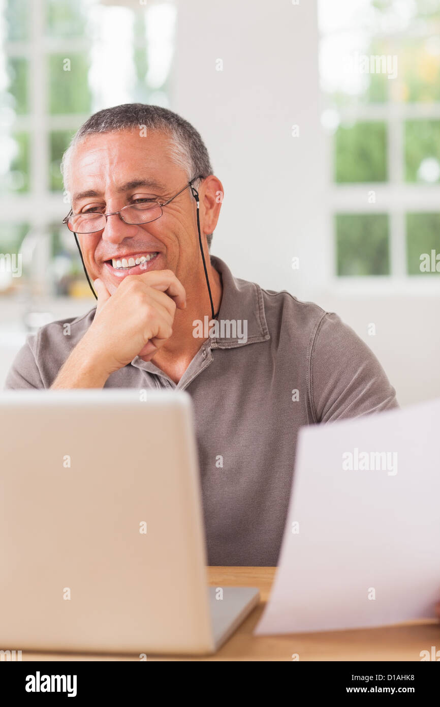 Happy man working at laptop Stock Photo - Alamy