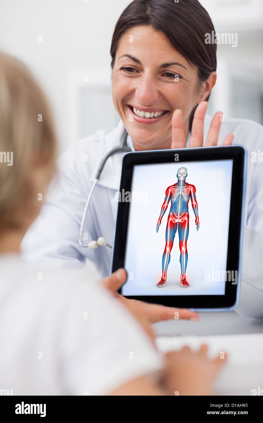 Smiling doctor showing a tablet computer to a child Stock Photo - Alamy