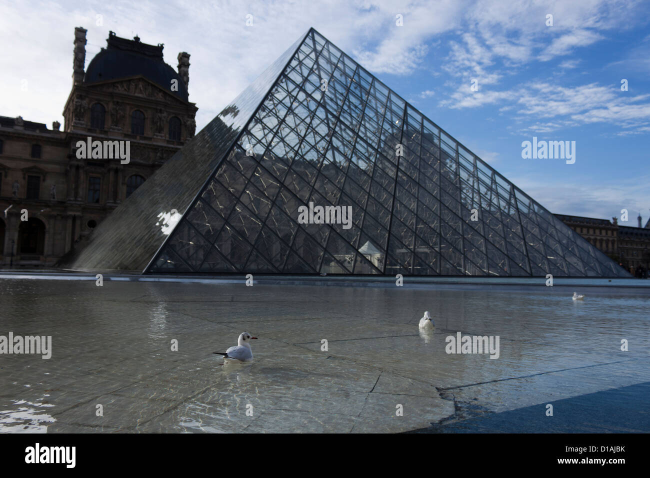 The Louvre glass pyramid and water feature, France Paris Stock Photo ...