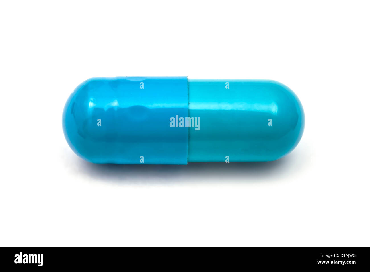 Blue capsule isolated on white background Stock Photo - Alamy