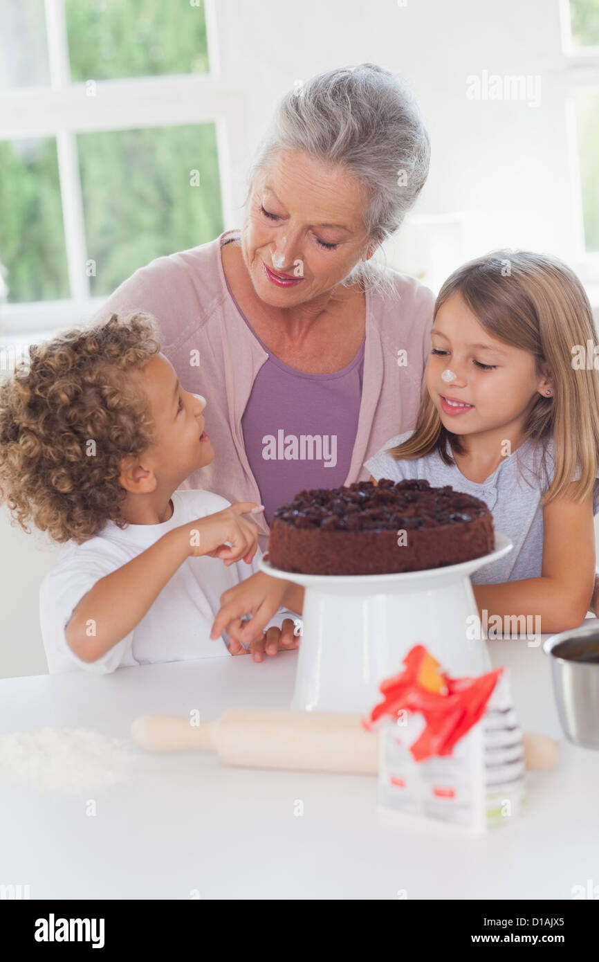Children making cake with granny Stock Photo - Alamy