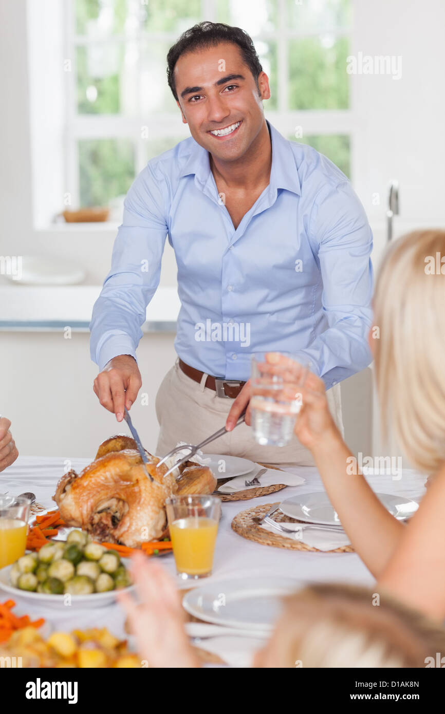 Smiling man carving the turkey Stock Photo - Alamy
