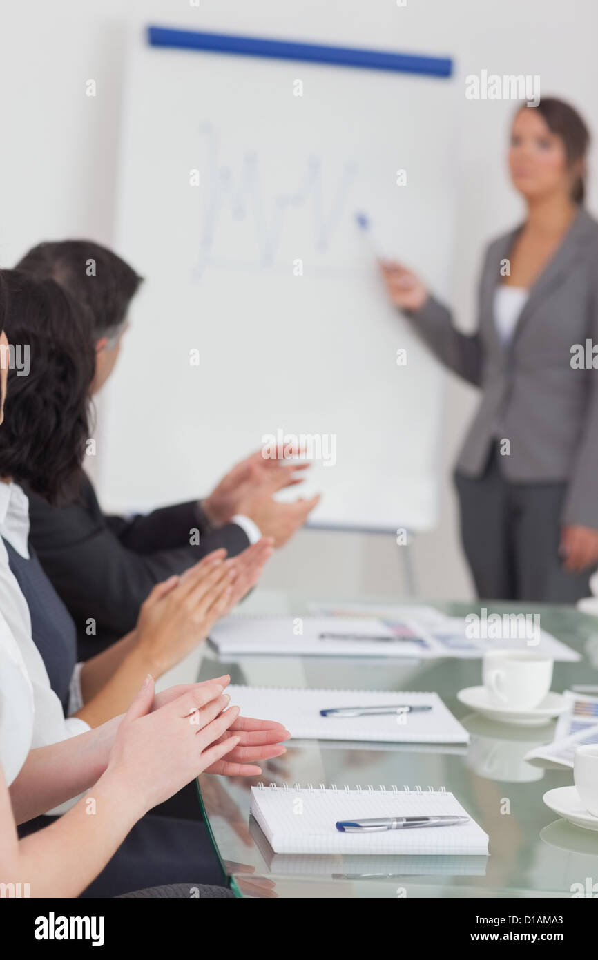 Businesswoman explaining and her colleagues clapping Stock Photo - Alamy