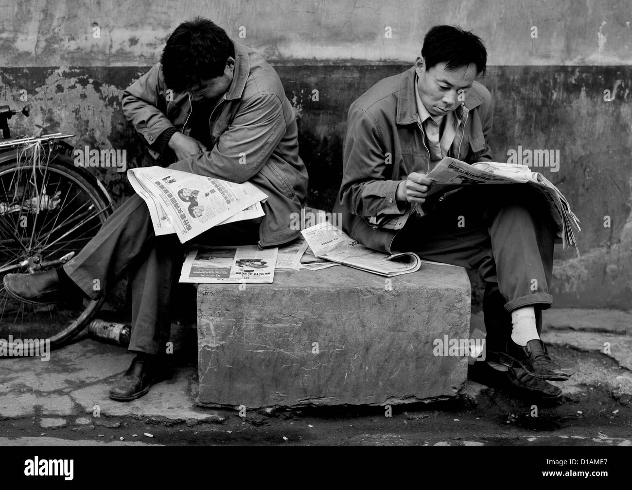 Men Reading Newspapers In A Hutong Street, Beijing China Stock Photo ...