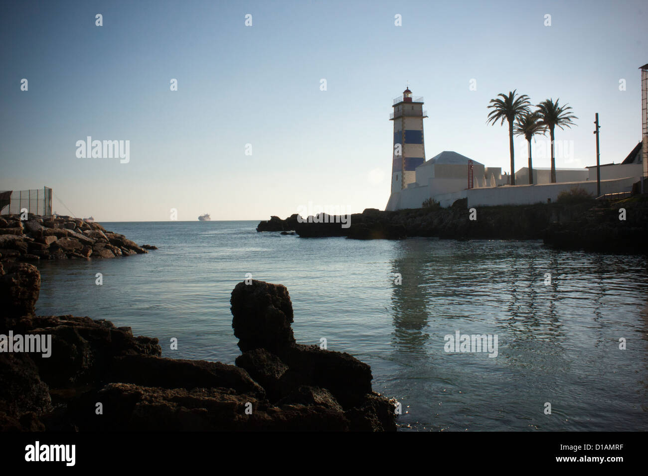 white Lighthouse Cascais harbor with blue sea water Stock Photo - Alamy