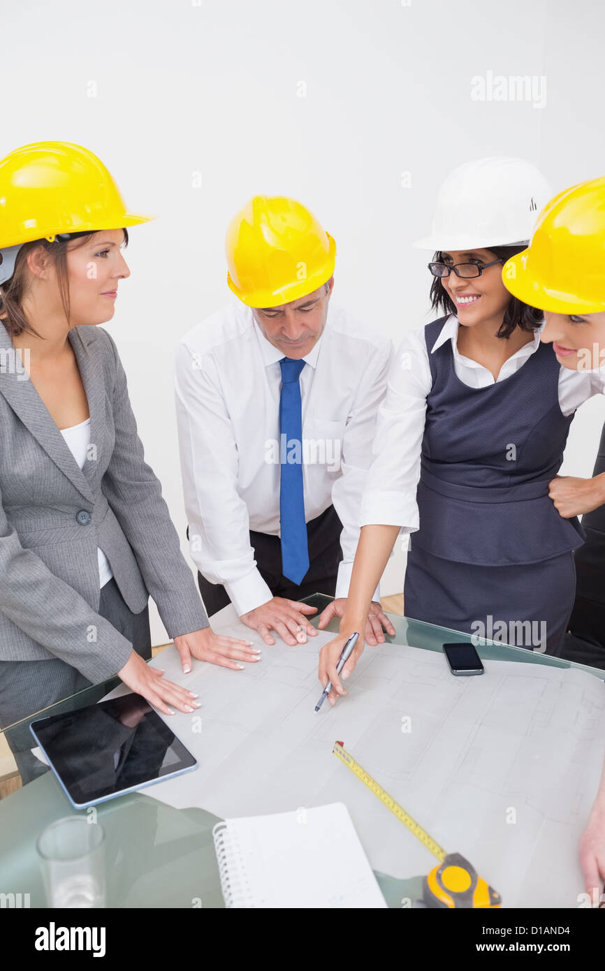Team looking at a construction plan and laughing Stock Photo - Alamy