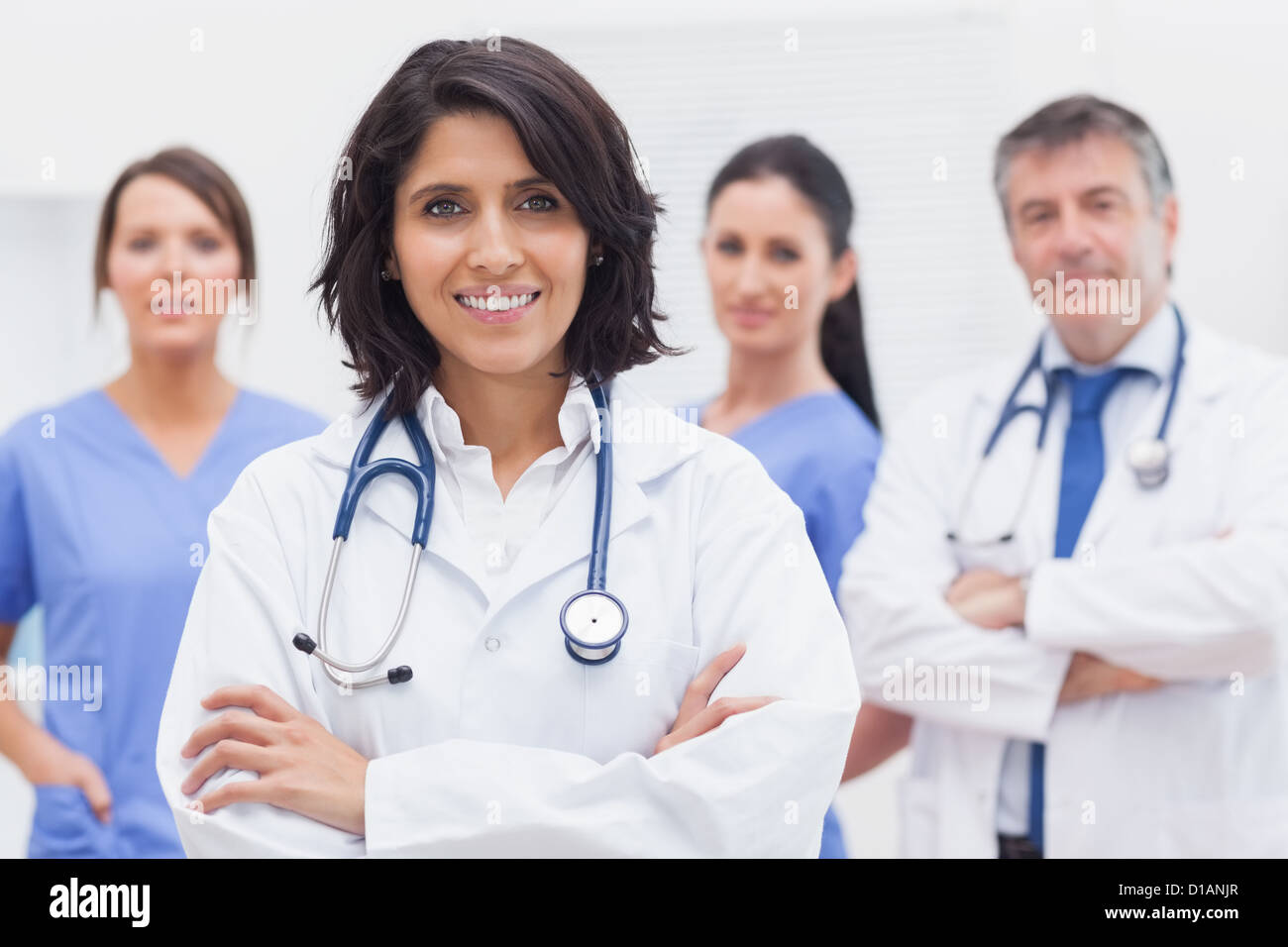 Female doctor and her team smiling Stock Photo - Alamy