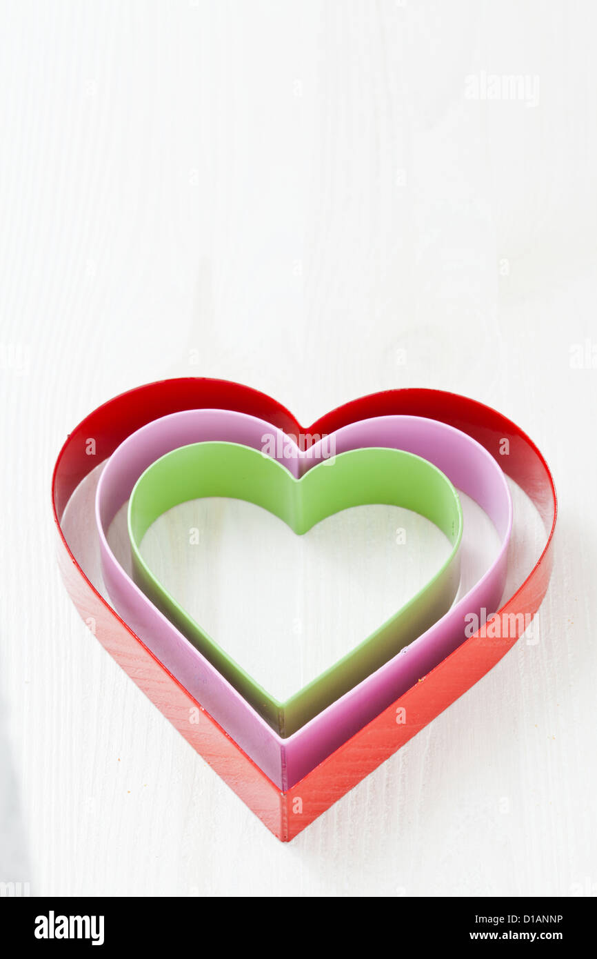 Colorful nested metal heart shapes on white background Stock Photo - Alamy