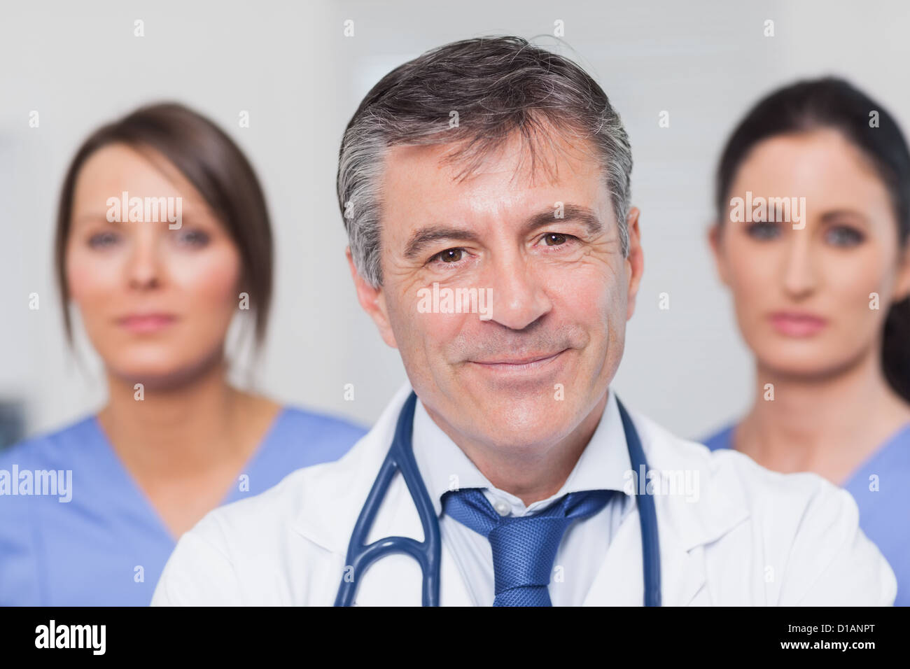 Smiling doctor with two nurses Stock Photo - Alamy