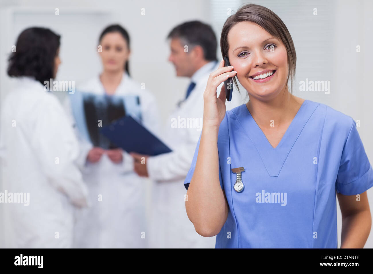 Nurse calling with her team Stock Photo - Alamy