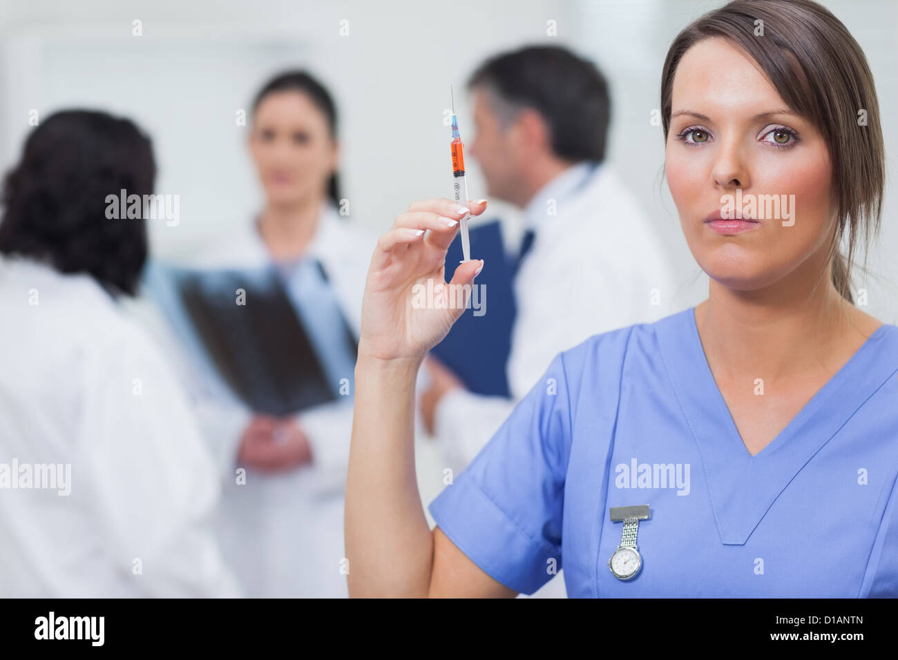 Nurse holding syringe Stock Photo - Alamy