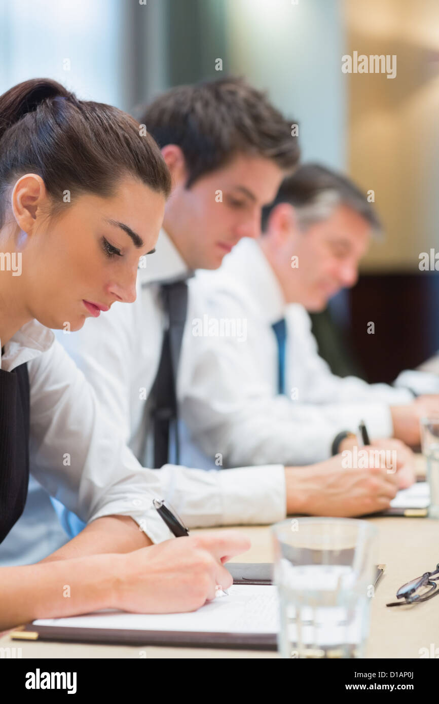 Concentrated business people taking notes Stock Photo - Alamy