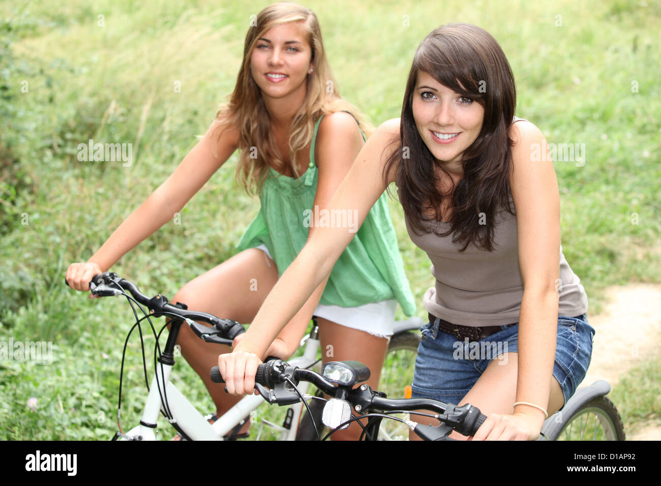 Two girls on a bicycle Stock Photo - Alamy