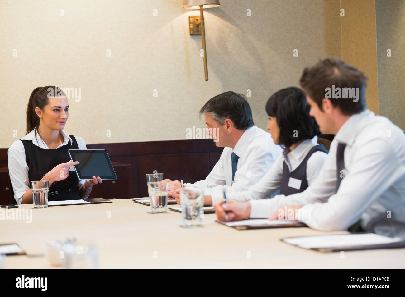 Businesswoman using tablet during presentation Stock Photo - Alamy