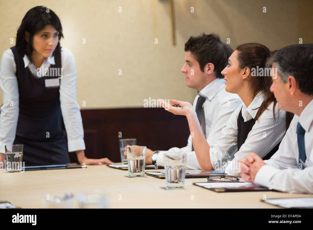 Woman asking question in business meeting Stock Photo - Alamy