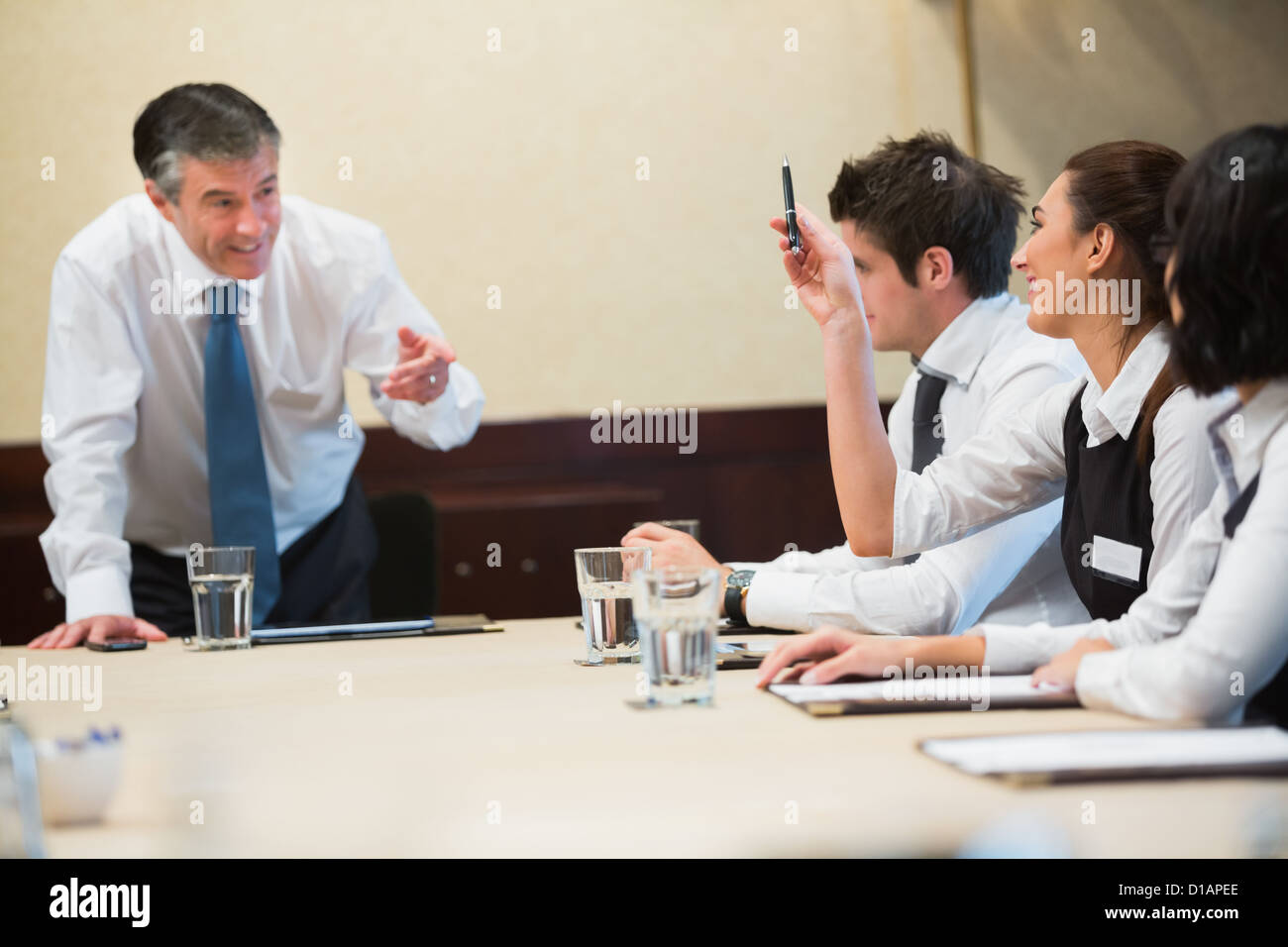Woman asking question in a business meeting Stock Photo - Alamy