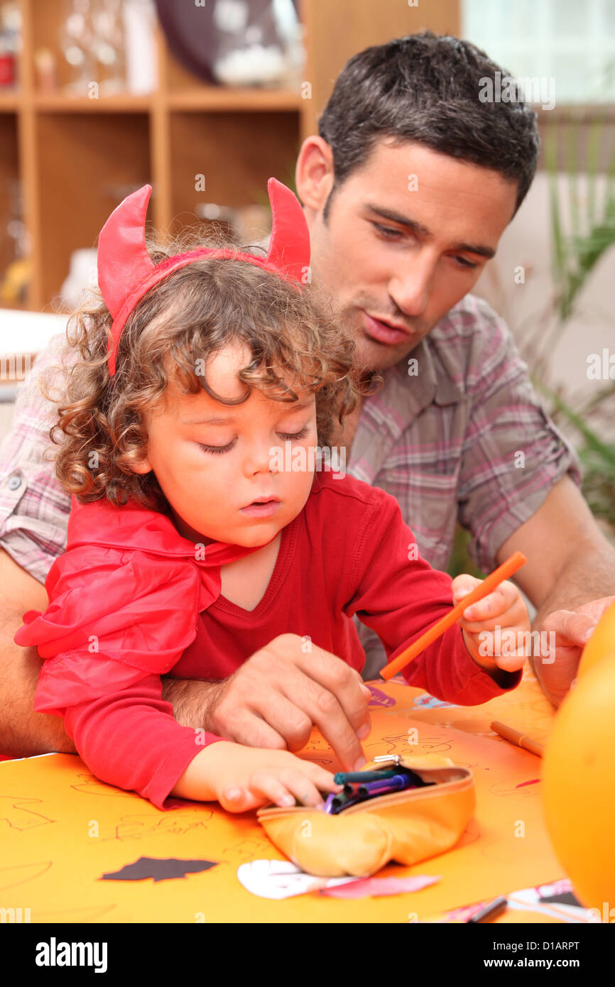 Father with children dressed as devil Stock Photo - Alamy
