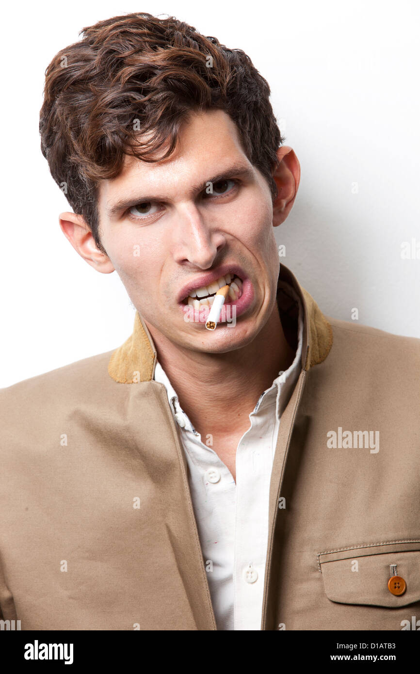 Portrait angry young man smoking over Stock Photo - Alamy