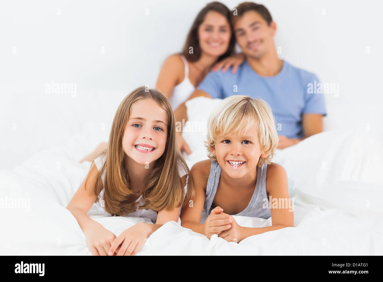 Children lying on the bed Stock Photo - Alamy
