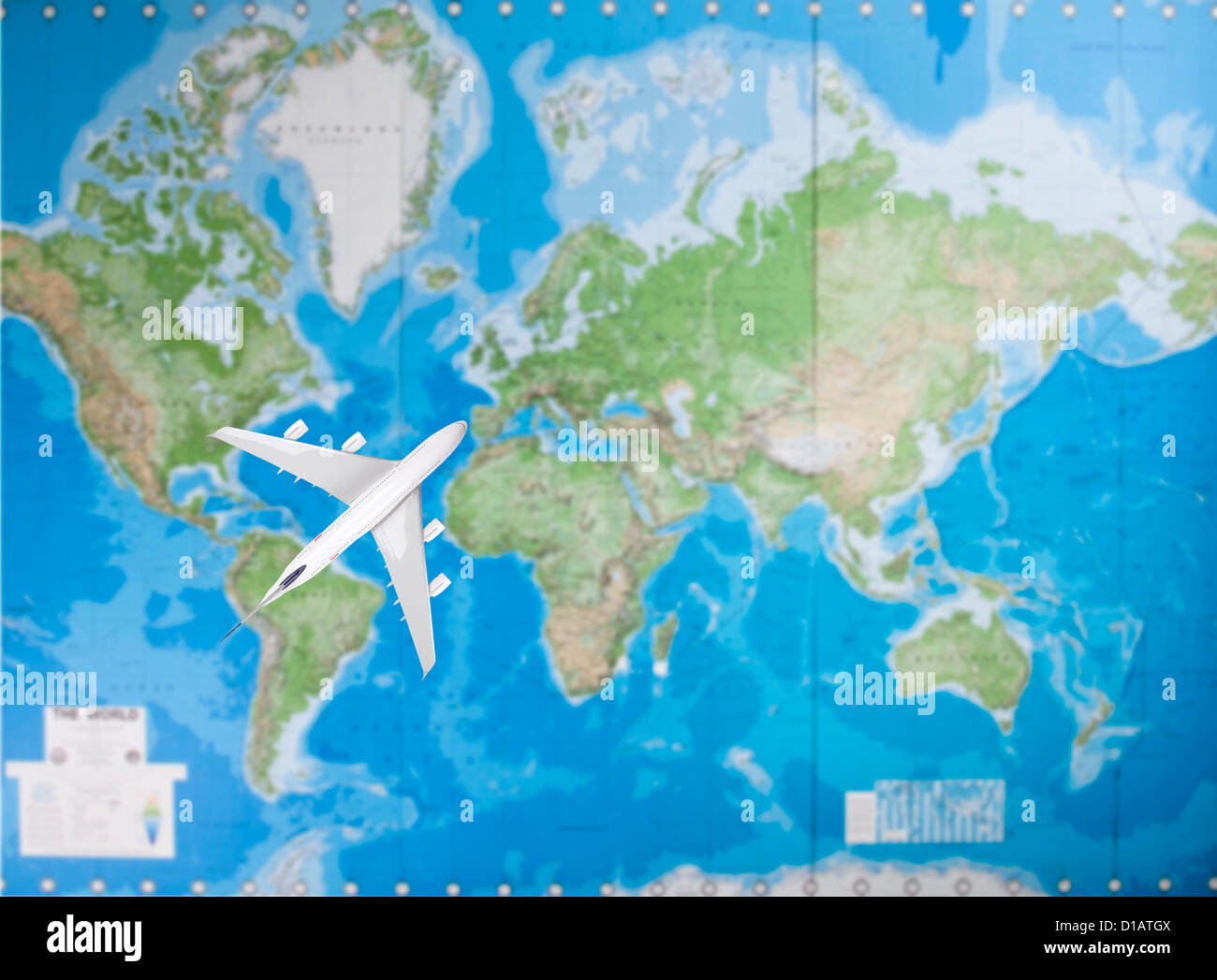 Model aircraft flying over world map Stock Photo - Alamy