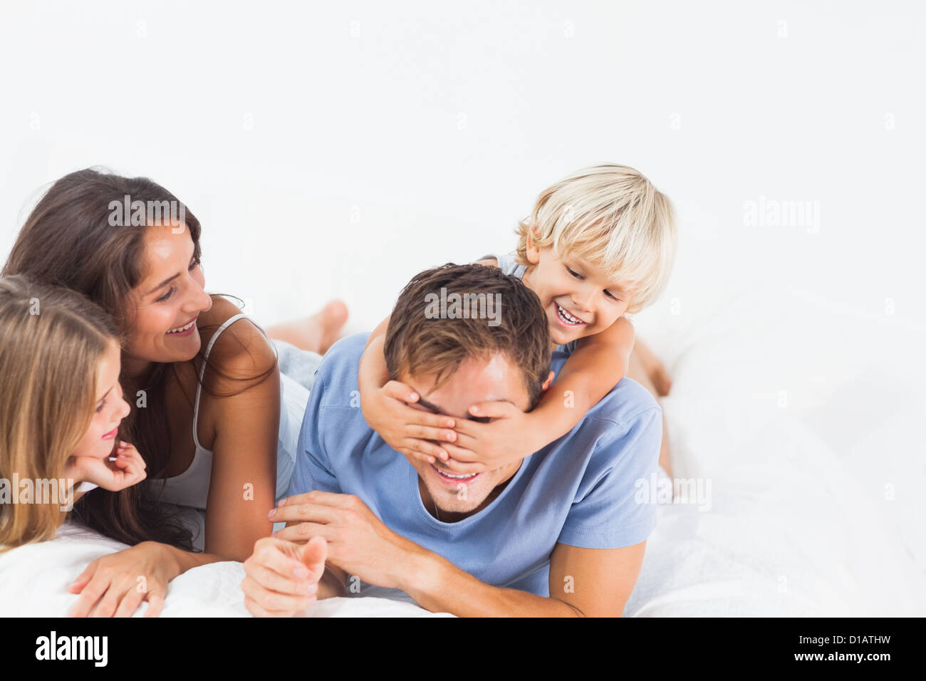 Happy family playing together Stock Photo - Alamy